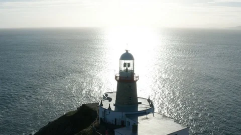 Silhouette of a lighthouse at the edge o... | Stock Video | Pond5