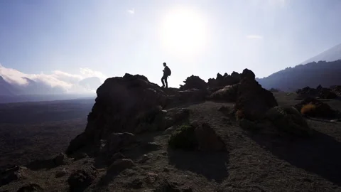 Silhouette of man exploring rocky landsc... | Stock Video | Pond5