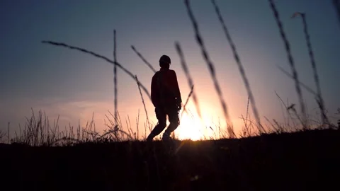 Silhouette of a man falls to his knees i... | Stock Video | Pond5