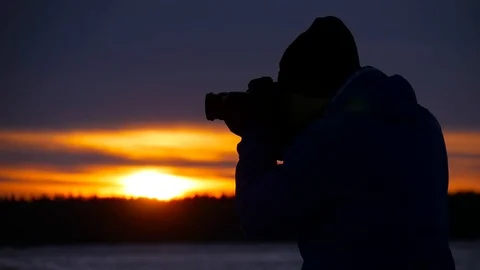 Silhouette of man photographer in sunset | Stock Video | Pond5