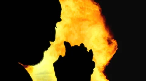 Silhouette man praying fire wind | Stock Video | Pond5