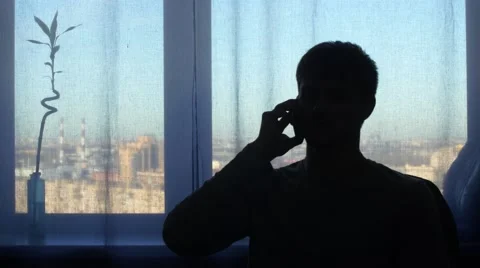 Silhouette man, talking at window backgr... | Stock Video | Pond5