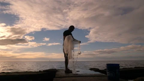 Silhouette of man throwing a cast net in... | Stock Video | Pond5