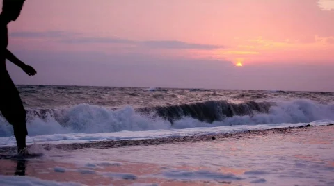silhouette of man walking to camera on b... | Stock Video | Pond5