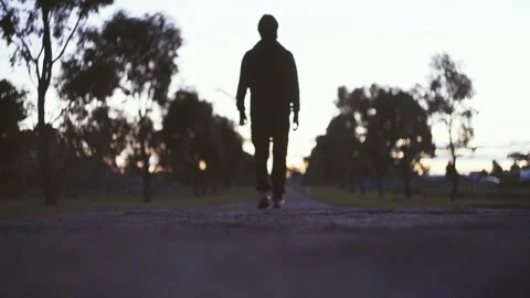 Silhouette Of A Man Walking On The Empty... | Stock Video | Pond5