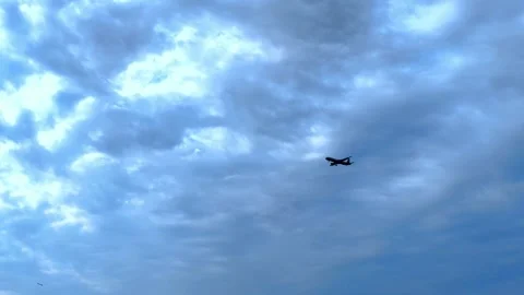 Silhouette of a plane flying before land... | Stock Video | Pond5