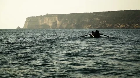 Silhouette of rowing team on a boat in f... | Stock Video | Pond5