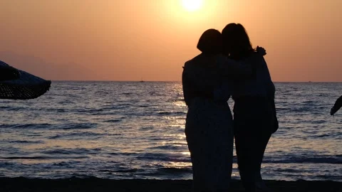 silhouette of two women hugging and walk... | Stock Video | Pond5