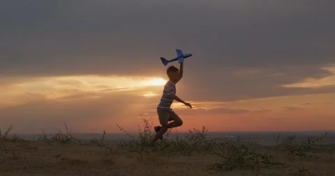 Silhouette view of little boy running wi... | Stock Video | Pond5