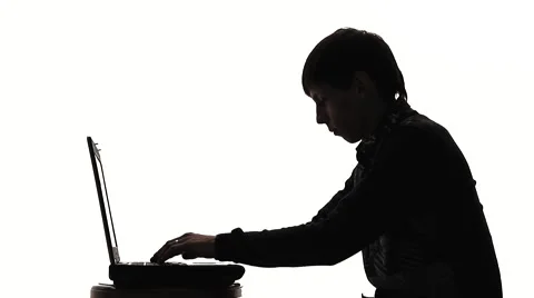 Silhouette Of Young Man Typing At Laptop | Stock Video | Pond5