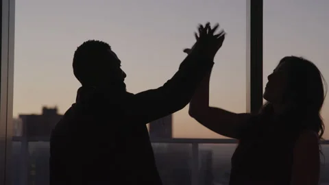 Silhouetted Corporate Duo High Five in a... | Stock Video | Pond5