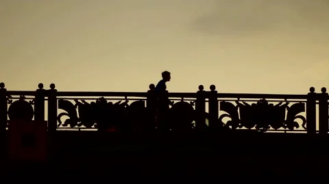 silhouettes of people go over the bridge | Stock Video | Pond5