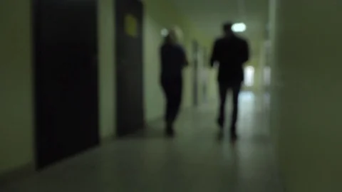 Silhouettes of people pass through the d... | Stock Video | Pond5