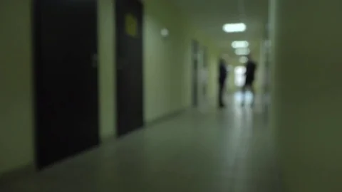 Silhouettes of people pass through the d... | Stock Video | Pond5