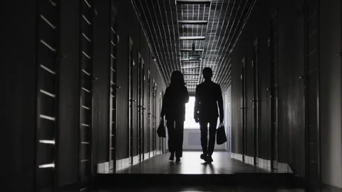 Silhouettes of Two People in Dark Hallwa... | Stock Video | Pond5