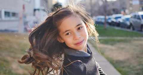 Silly little girl on the sidewalk playfu... | Stock Video | Pond5