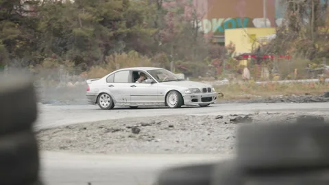 Silver BMW sliding on race track sideway... | Stock Video | Pond5