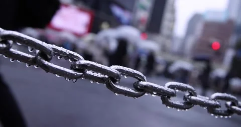 A silver chain behind walking people at ... | Stock Video | Pond5