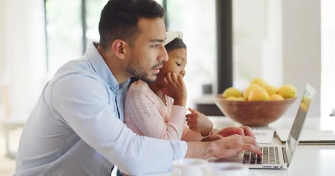 Single father typing on laptop and worki... | Stock Video | Pond5