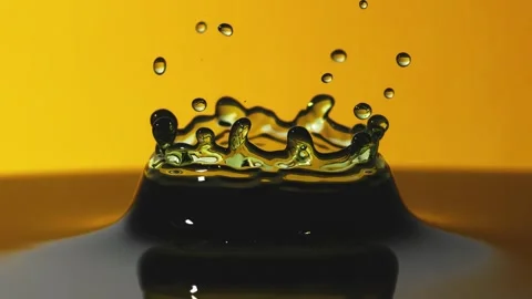 Single green water drop splashing into p... | Stock Video | Pond5