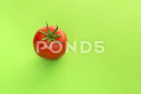 Single real tomato seen at its top on a green background ~ Premium ...