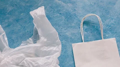 single use plastic bag next to paper one... | Stock Video | Pond5