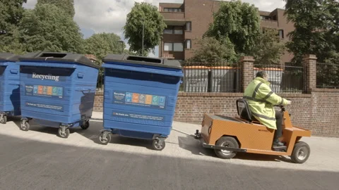 Sit on tow bin tug transporting recyclin... | Stock Video | Pond5