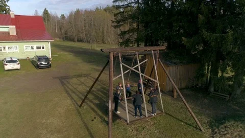 Six adults swinging on the large swing i... | Stock Video | Pond5