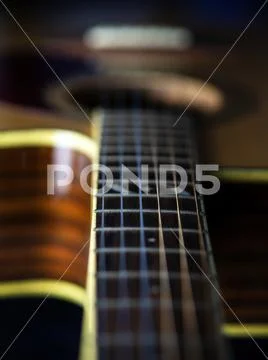 Six - string acoustic guitar on a black background. low key. music day ...