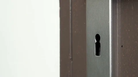 Skeleton key going into old keyhole lock... | Stock Video | Pond5