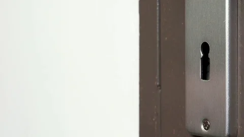 Skeleton key going into old keyhole lock... | Stock Video | Pond5