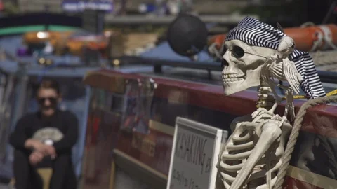 Skeleton sunbathing wearing a bandana | Stock Video | Pond5