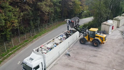 Skid steer loader loading a truck with w... | Stock Video | Pond5