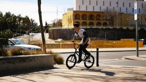 Skilled guy bmx rider is riding in stree... | Stock Video | Pond5
