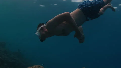 Skin diving. Young fit man dives with ma... | Stock Video | Pond5