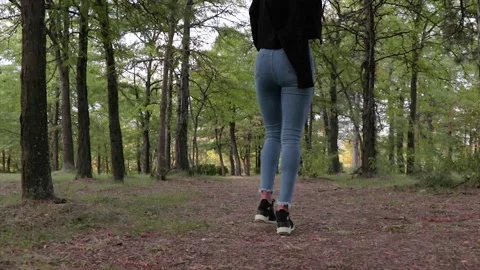 Skinny female model walking in a park lo... | Stock Video | Pond5