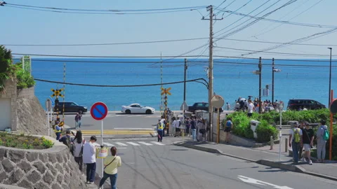 SLAM DUNK fans visit to Enoden Railroad ... | Stock Video | Pond5