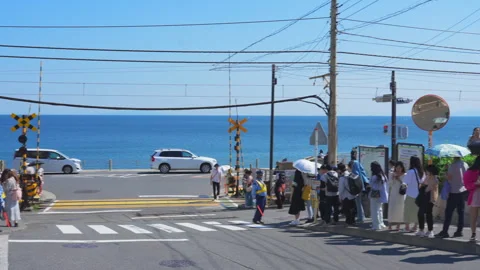 SLAM DUNK fans visit to Enoden Railroad ... | Stock Video | Pond5