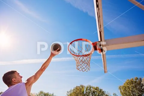 Slam Dunk. Side view of young basketball player making slam dunk ~ Hi ...