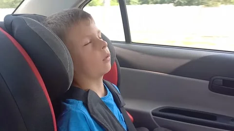 sleeping child rides in back seat of car... | Stock Video | Pond5