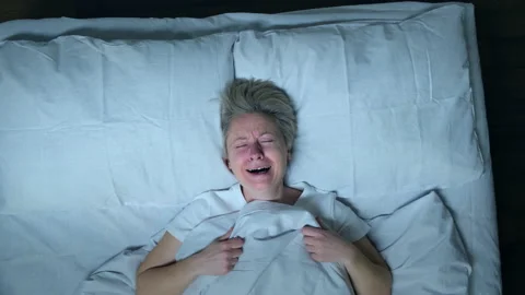 Sleeping man crying in his sleep in bed,... | Stock Video | Pond5