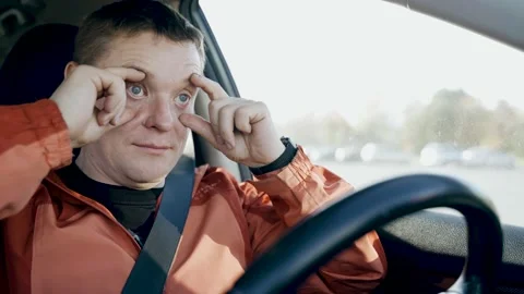The sleepy driver opens his eyes with hi... | Stock Video | Pond5