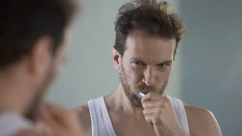 Sleepy man brushing teeth, tired of rout... | Stock Video | Pond5