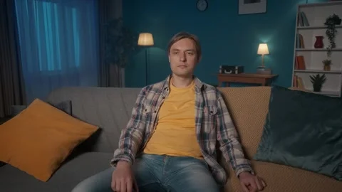 Sleepy tired man watching TV while sitti... | Stock Video | Pond5