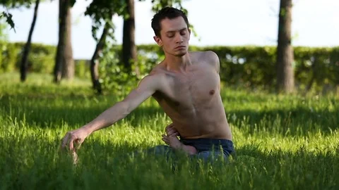 Slender handsome guy practicing yoga in ... | Stock Video | Pond5