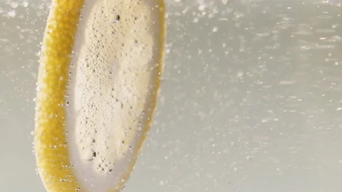 Slice of lemon rotate with bubbles Macro... | Stock Video | Pond5