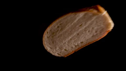 Sliced white bread falling into dark bac... | Stock Video | Pond5