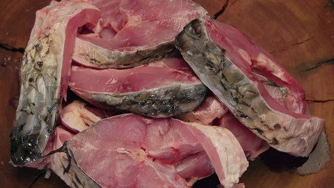 Slices of raw carp on a wooden table rea... | Stock Video | Pond5
