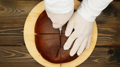 Slicing a loaf of bread into quarters. H... | Stock Video | Pond5