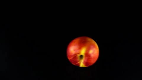 Sliding apple on a black background. | Stock Video | Pond5